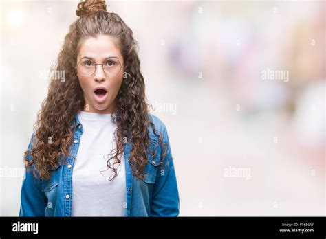 Beautiful Young Brunette Curly Hair Girl Wearing Glasses Over Isolated