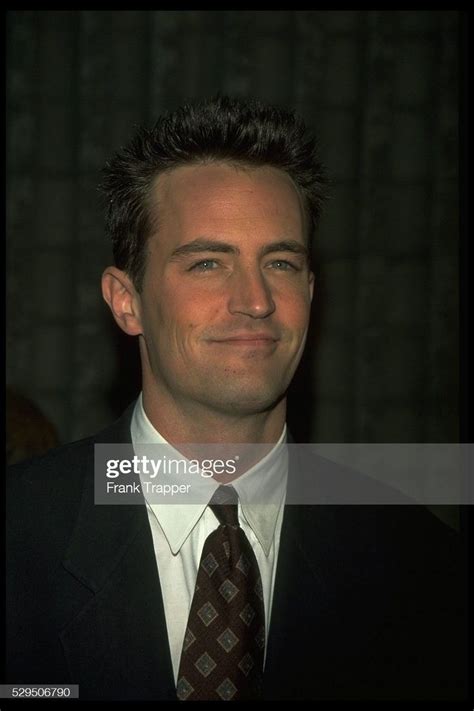 A Smiling Man In A Suit And Tie