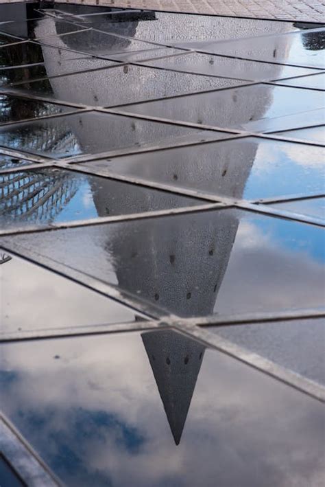 Geometric Reflection Of Architectural Structure On Wet Pavement · Free