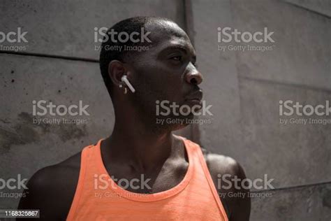 Badass 스타일 초상화 의 젊은 매력적이고 운동 블랙 Afro 미국 스포츠 남자 실행 싱글 T 찾고 콘크리트 도시 벽 배경에 선수 거리 운동 개념 20 29세에 대한