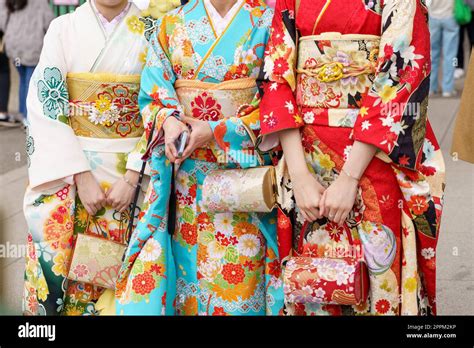 Young Girl Wearing Japanese Kimono Standing In Front Of Sensoji Temple