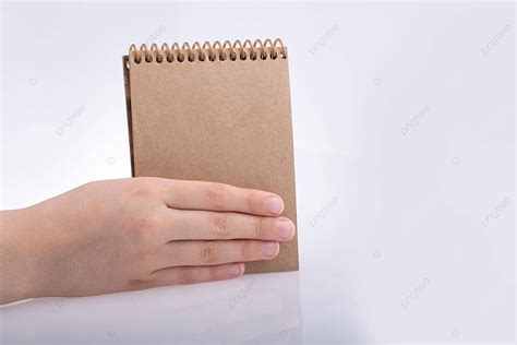 Hand Holding A Brown Color Notebook Sheet Writing Hand Photo Background And Picture For Free