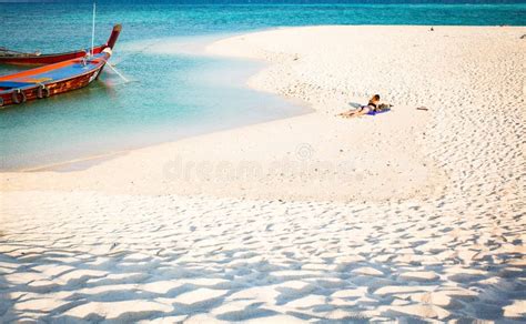 Woman Sunbathing Alone On An Idyllic Stretch Of Sand Tropical Holiday