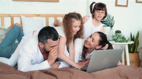 Dad Mom And Two Daughters Play In Computer Game On Laptop Slow Motion