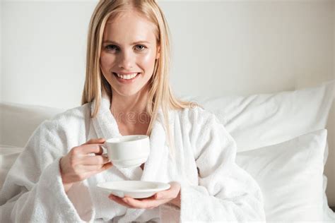 Happy Smiling Woman In Bathrobe Holding Cup Of Coffee Stock Image