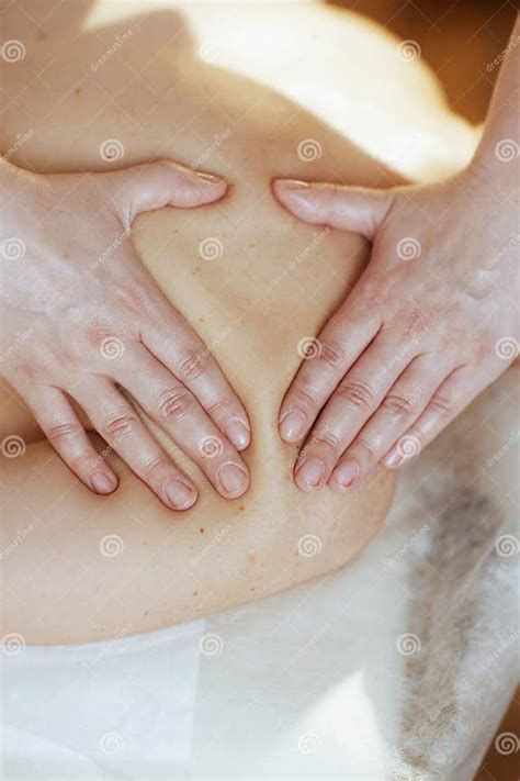 Medical Massage Therapist In Massage Cabinet Massaging Client Stock