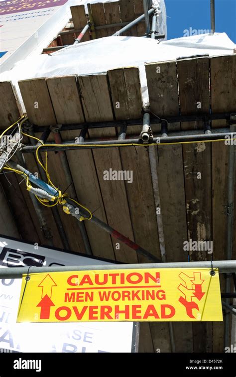 Caution Men Working Overhead Sign At A Building Site In Putney