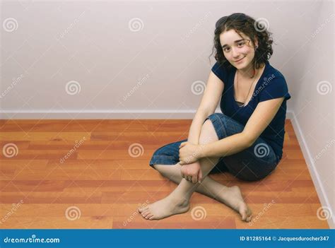 Young Girl Brunette Sitting Onrange Wooden Floor Barefoot Stock