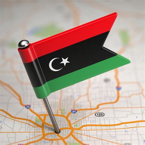 Premium Photo Small Flag State Of Libya On A Map Background With