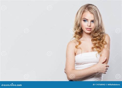 Fashion Portrait Of Beautiful Young Woman With Blonde Hair On White