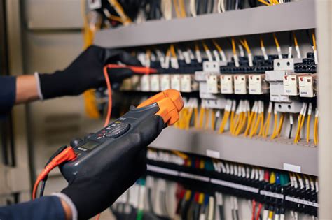 전기 엔지니어 작업 테스터 는 전기 캐비닛 제어에서 전력 전기 라인의 전압과 전류를 측정하고 릴레이 보호 시스템에 전선 베이 제어 장치 중간 전압 개폐기 기술자에 대한 스톡