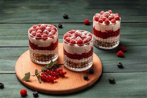 Premium Photo Raspberry Dessert Cheesecake Trifle Mouse In A Glass On A Wooden Background