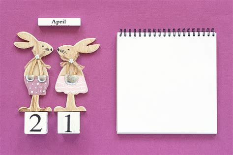 4 월 21 일 일정 및 자주색 용지에 나무 부활절 토끼 흰 메모장의 쌍 글자 텍스트 또는 디자인 크리에이 티브 탑 뷰 개념