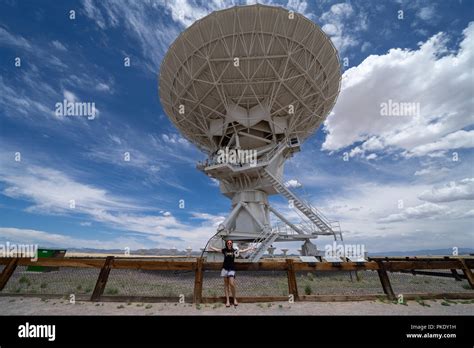 Beautiful Woman Poses To Show Scale Of The Very Large Array Located In