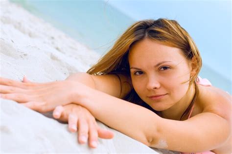 Premium Photo Portrait Of Beautiful Woman Lying On Beach