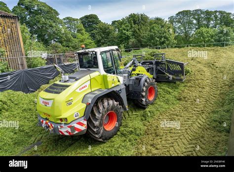 Working On A Silage Clamp With A Claas Laoder Using A Big Loader Grab