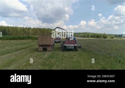 Drone View Of Two Combines Harvesting On Grass Field The Harvesters