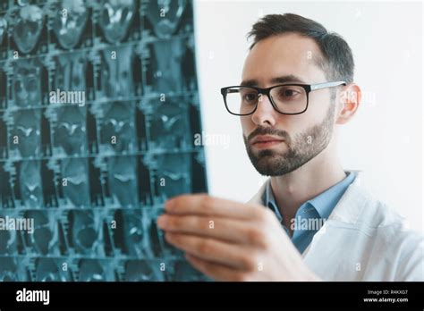 Young Doctor Looking At Magnetic Resonance Imaging Shot Of Knee Joint