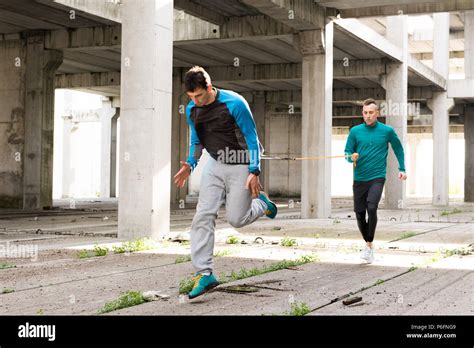 Young Handsome Athlete Man Doing Exercise In An Old Abandoned Building
