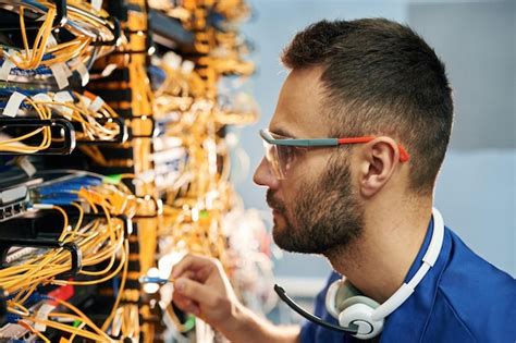 Premium Photo Modern Technology Routing Young Man Is Working With Internet Equipment And Wires