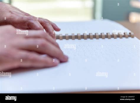 Blind Or Visually Impaired Person Reading A Book Printed With Braille Characters Stock Photo Alamy