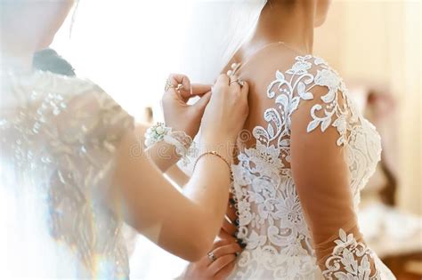Gorgeous Blonde Bride In White Luxury Dress Is Getting Ready For