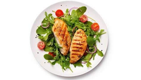 Premium Photo A White Plate Topped With Meat And Vegetables