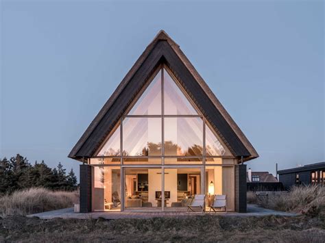 A Thatched Roof And Charred Wood Siding Were Used To Create This Modern