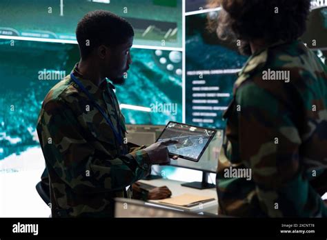 Military Personnel Collecting Data From Satellite Surveillance Imagery Examining Information