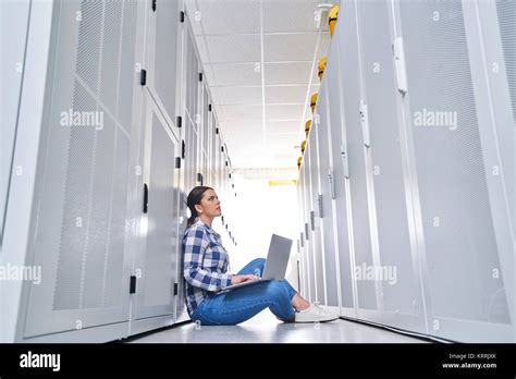 Female Technician Working On Server Maintenance In White Server Room
