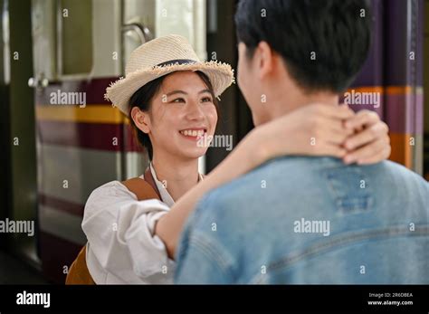 A Beautiful And Lovely Young Asian Girl Embraces The Neck Of Her