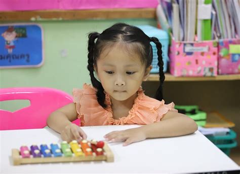 Premium Photo Portrait Of Cute Girl Sitting On Table