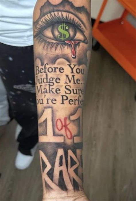 A Person With A Tattoo On Their Arm That Says Before You Judge Me Make