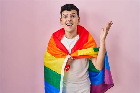 Premium Photo Non Binary Person Holding Rainbow Lgbtq Flag Celebrating Victory With Happy