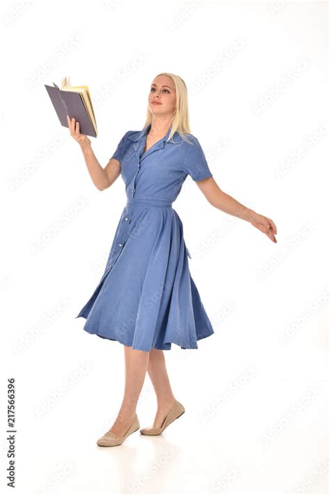 Full Length Portrait Of Blonde Girl Wearing Blue Dress Standing Pose