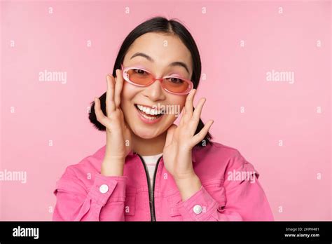 Cute Modern Japanese Girl In Sunglasses Smiling And Looking Happy