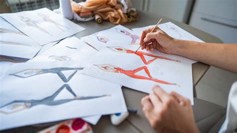 Faceless Woman Draws Watercolor Sketches Of Sportswear Close Up Of The