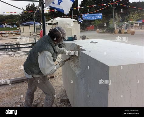 Sculpturing In Stone Artist Forming A Large Limestone With A Power Tool Photographed In Maalot