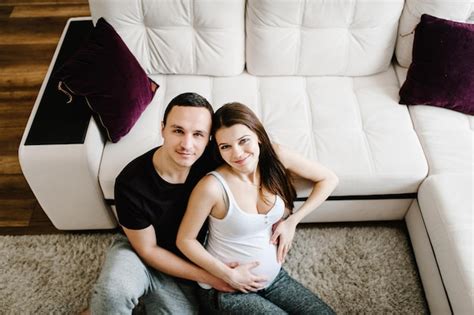 Premium Photo Image Of Husband Sitting And Holding Belly Of Pregnant Wife Hands Woman Girl And