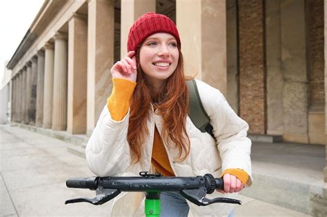 Free Photo Young Smiling Redhead Girl Student Rides Electric Scooter