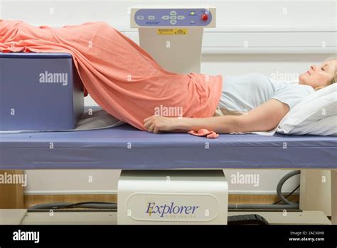 Patient Lying On A Dexa Dual Energy X Ray Absorbtiometry Scanner Dexa Scans Reveal Bone
