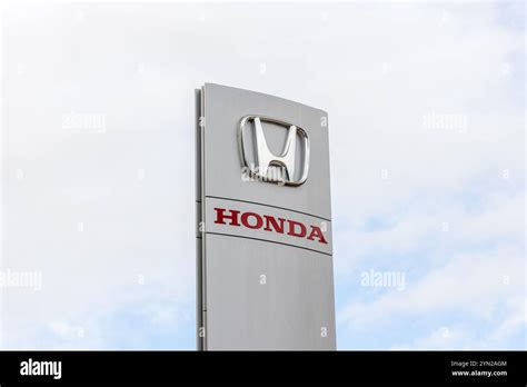 Honda Dealership Sign Displaying The Iconic Logo Against A Backdrop Of