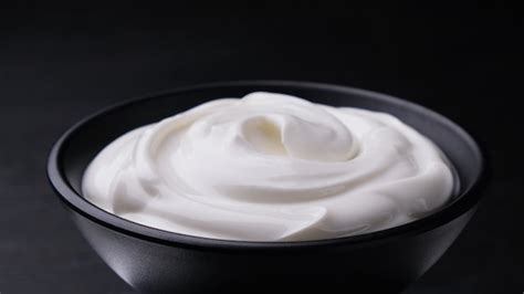 Premium Photo Bowl Of Sour Cream On Black Surface