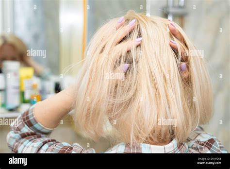 Woman Fixing Her Hair Standing In Front Of A Mirror Girl Fixing Her