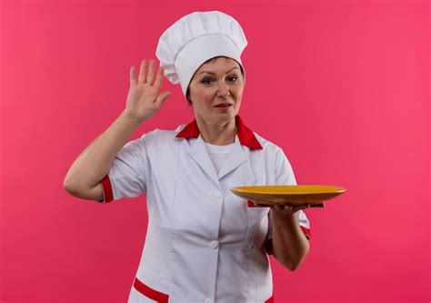 Free Photo Middle Aged Female Cook In Chef Uniform Holding Plate Give
