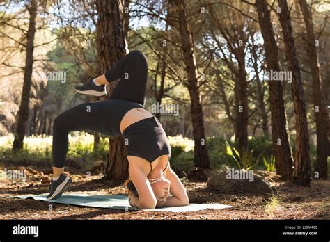 Attractive Young Adult Girl Doing Difficult Yoga Posture At Sunset In A