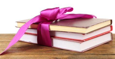 Premium Photo Stack Of Books With Ribbon On Table Isolated On White