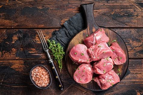Premium Photo Raw Pork Sliced Tenderloin Fillet Meat For Medallions Steaks On A Wooden Cutting