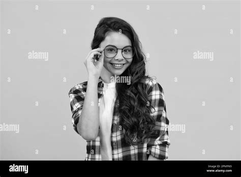 Cute School Girl Wearing Glasses On Yellow Studio Background Smart