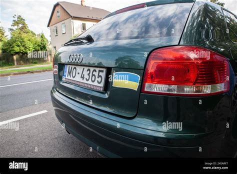 Picture Of A Latvian Car With A Ukrainian Flag Standing In The Streets